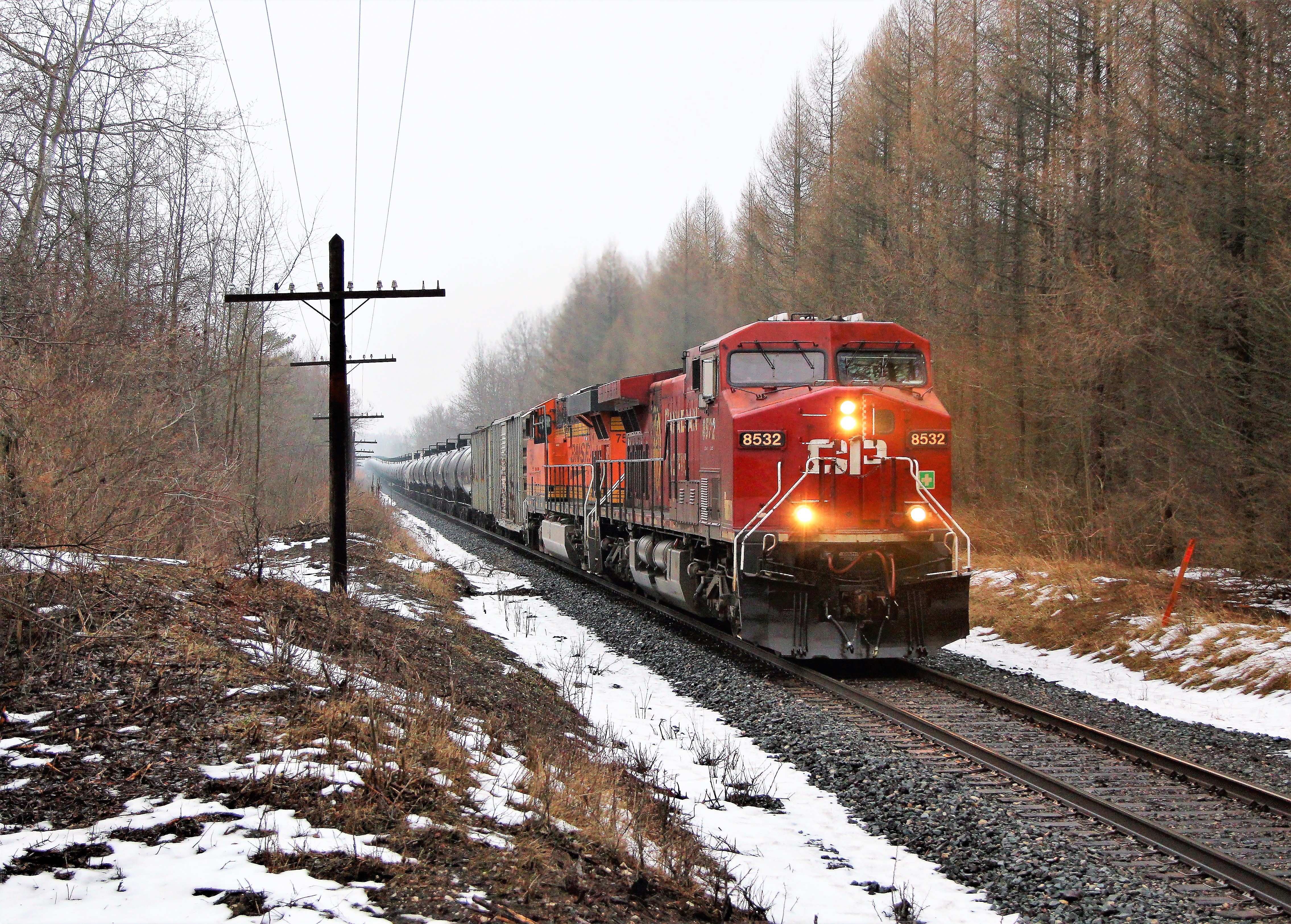 Railpictures.ca - BPurdy Photo: Through the mist and fog comes a westbound empty tanker train ...