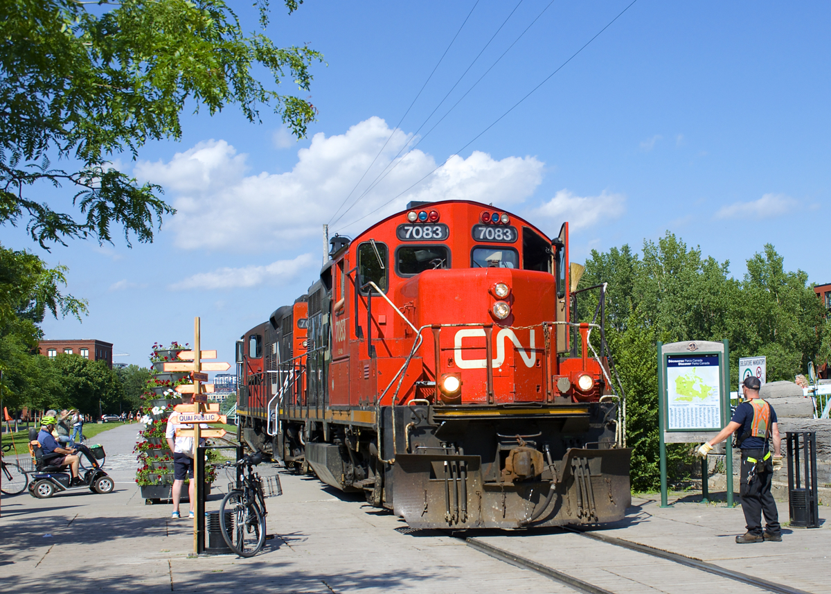 Railpictures.ca - Michael Berry Photo: A crewmember is flagging a pedestrian crossing beside the ...