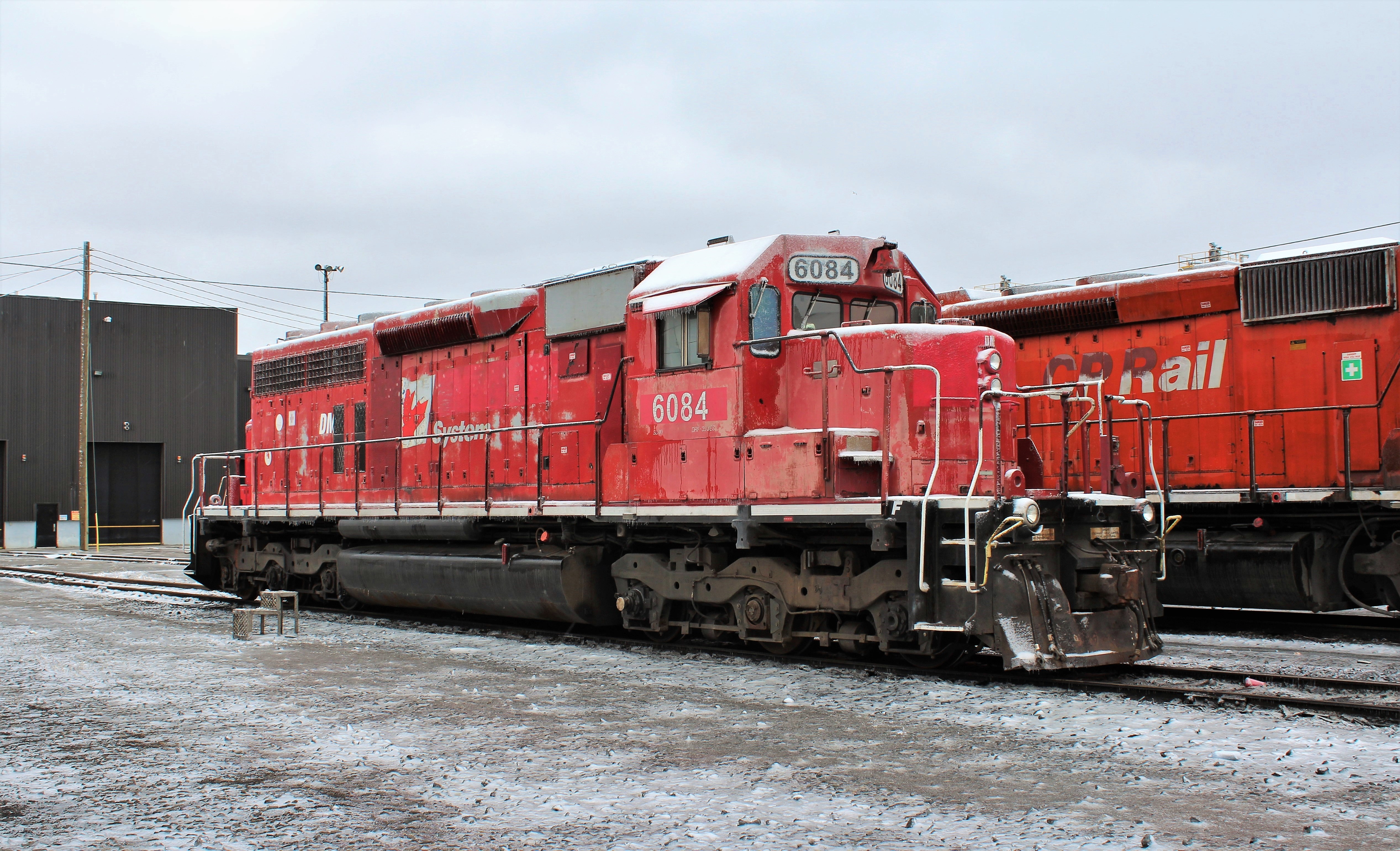Railpictures.ca - Paul Santos Photo: DME 6084 is parked at the east end of the shop awaiting it ...