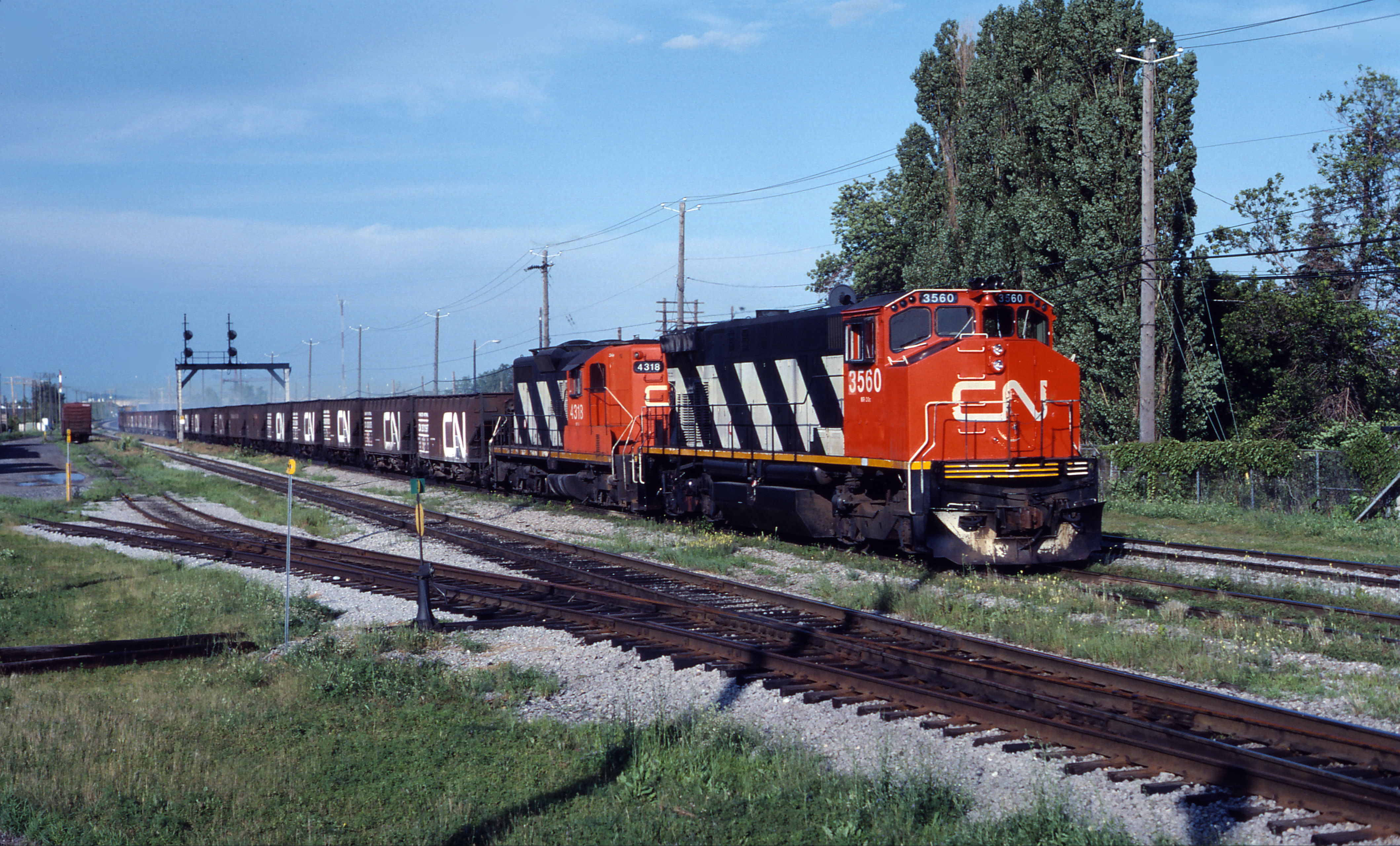 Railpictures.ca - John Eull Photo: CN M420W 3560 and GP9 4318 lead a ballast train through St ...