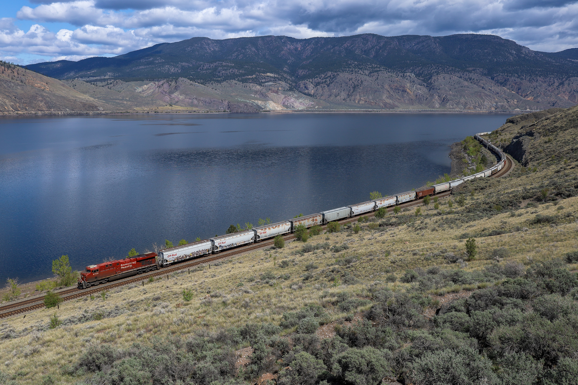 Railpictures.ca - Rob Eull Photo: CPKC 303-518 skirts the shores of Kamloops Lake, as CN G 84141 ...