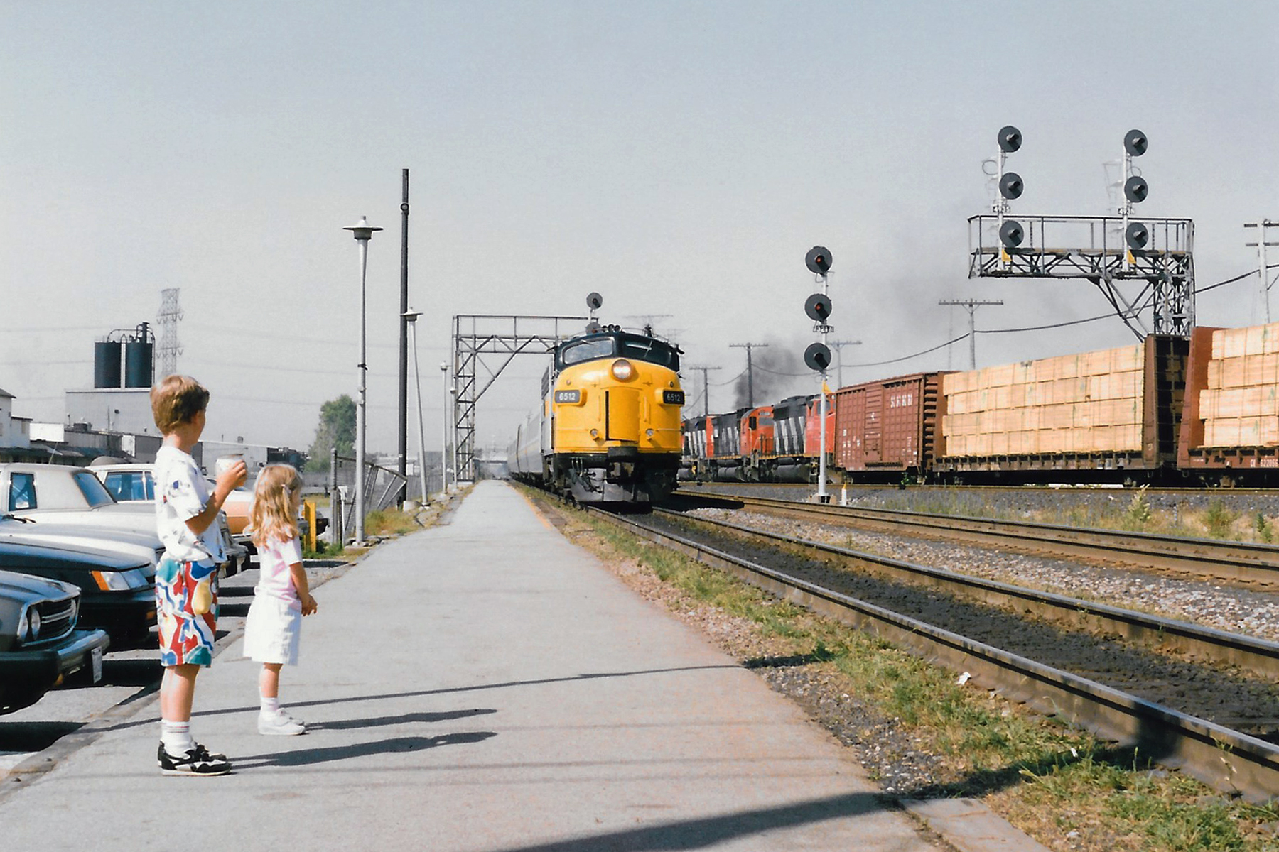 Railpictures.ca - GO564 Photo: Two children look on as VIA 70 arrives ...